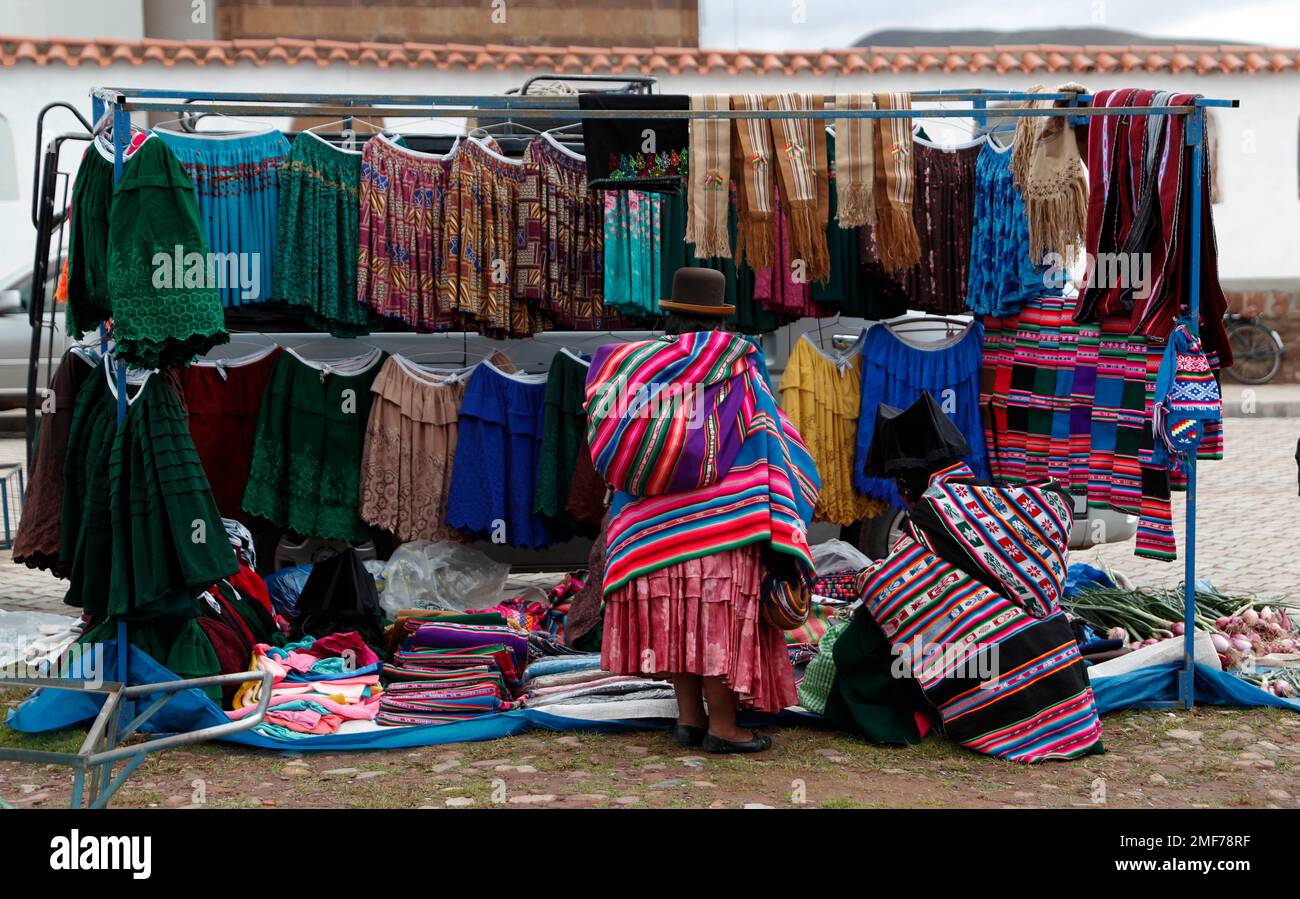 Aymara Indigenous women shop for "chola" skirts at a roadside stand in ...