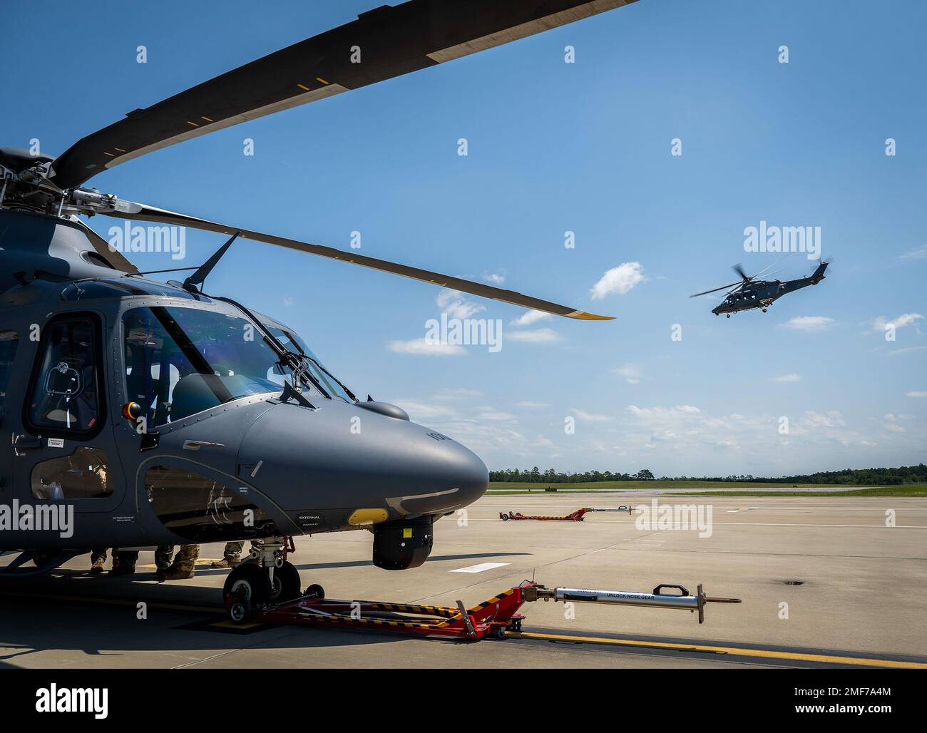 An MH-139A Grey Wolf sits on the flightline as another flies by Aug. 17 ...