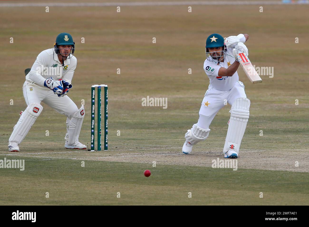 Pakistan's Baber Azam, right, bats while South Africa's Quinton de Kock ...