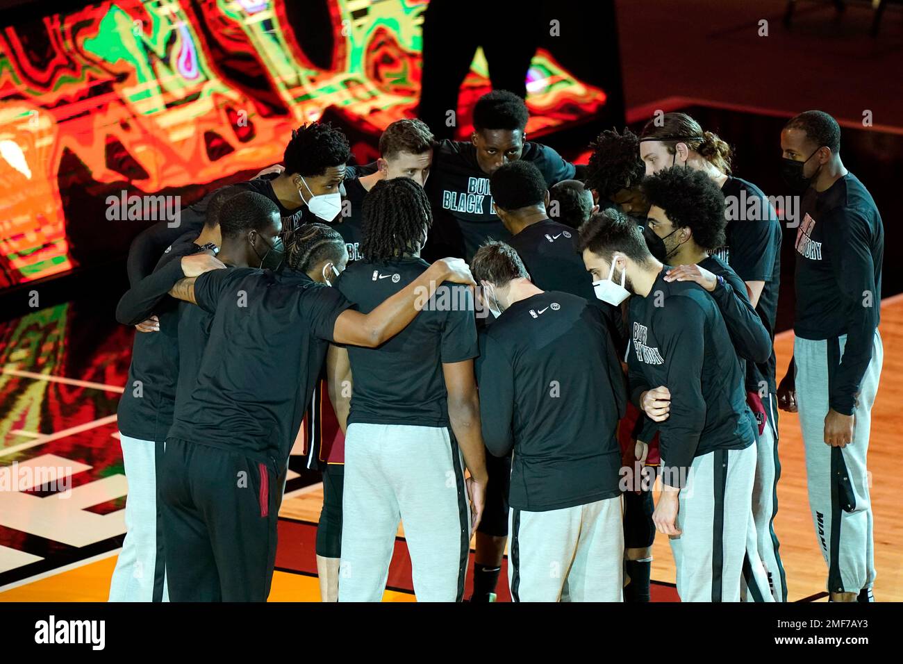 Miami Heat players meet before an NBA basketball game against the ...