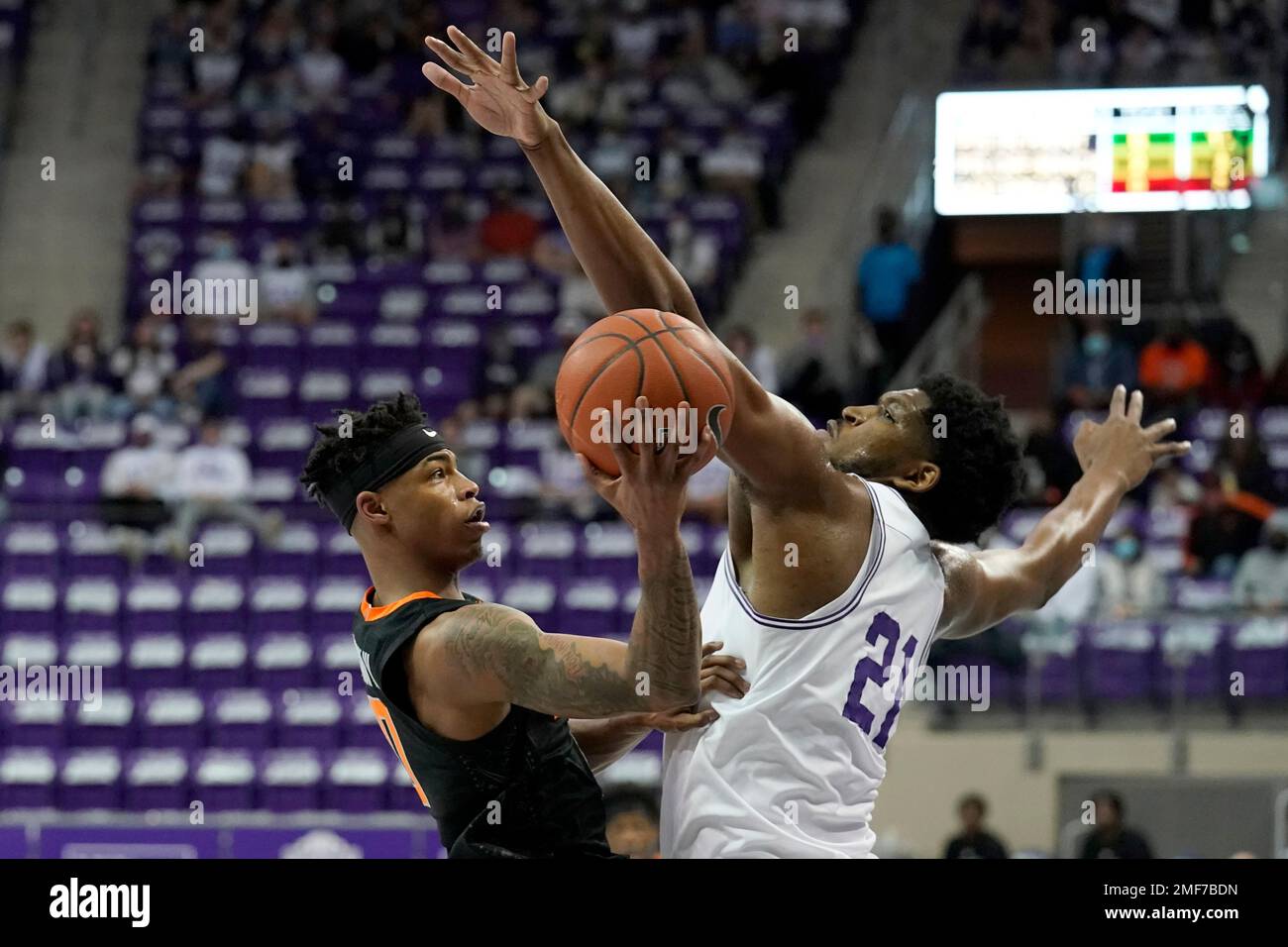 Oklahoma State guard Avery Anderson III (0) shoots as TCU's Kevin Samuel (21) defends during the ...