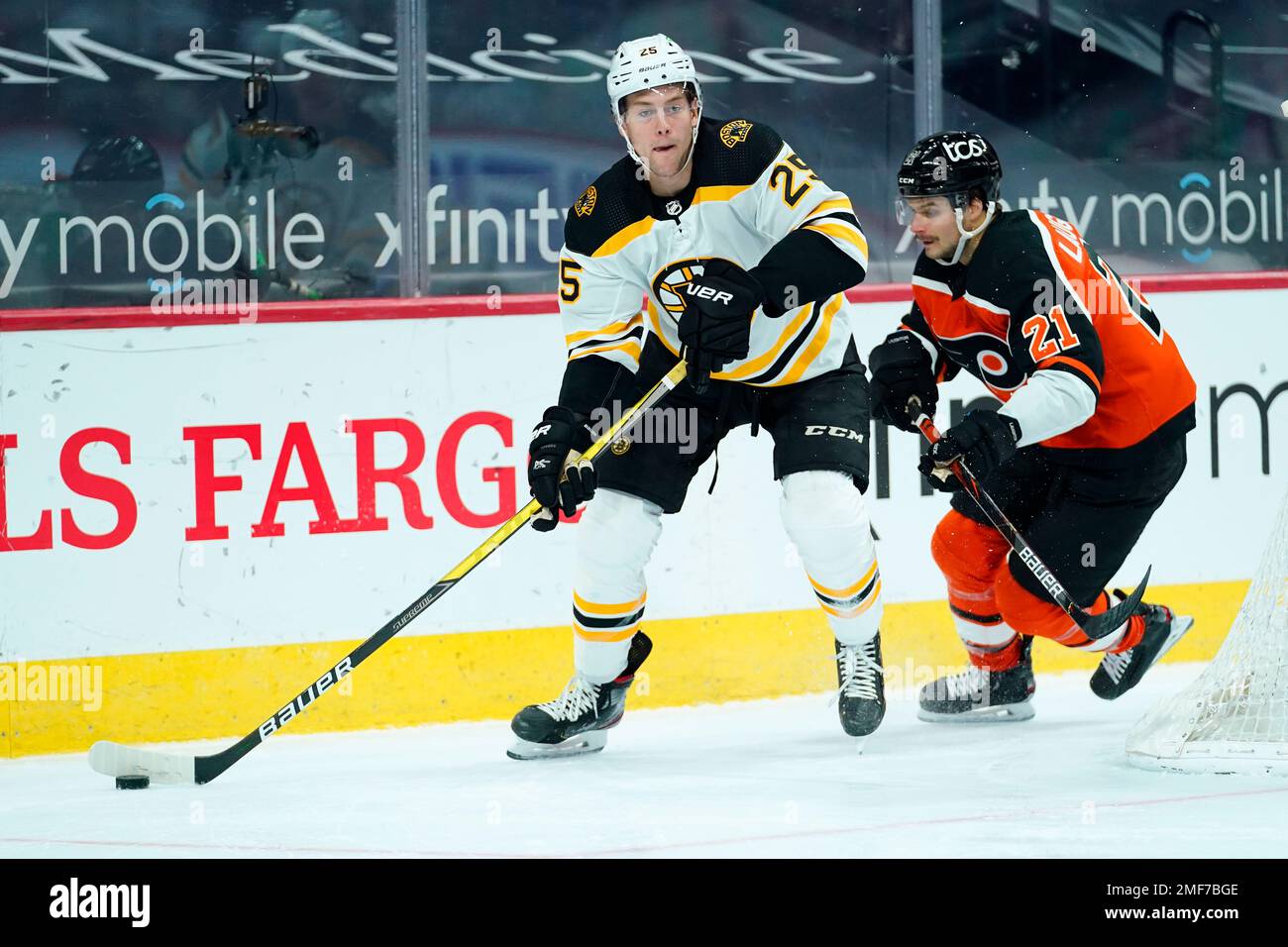Boston Bruins' Brandon Carlo (25) skates past Philadelphia Flyers ...