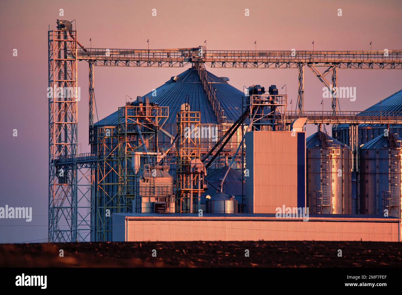 Large agricultural grain processing plant at sunset Industrial ...