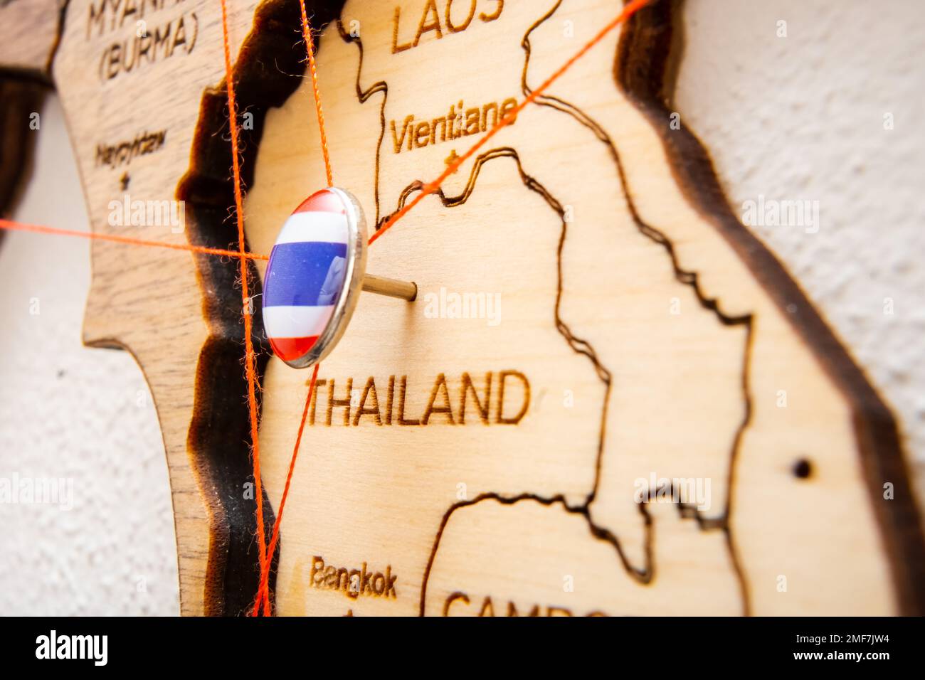 Thailand flag on the pushpin with red thread showed the paths of ...