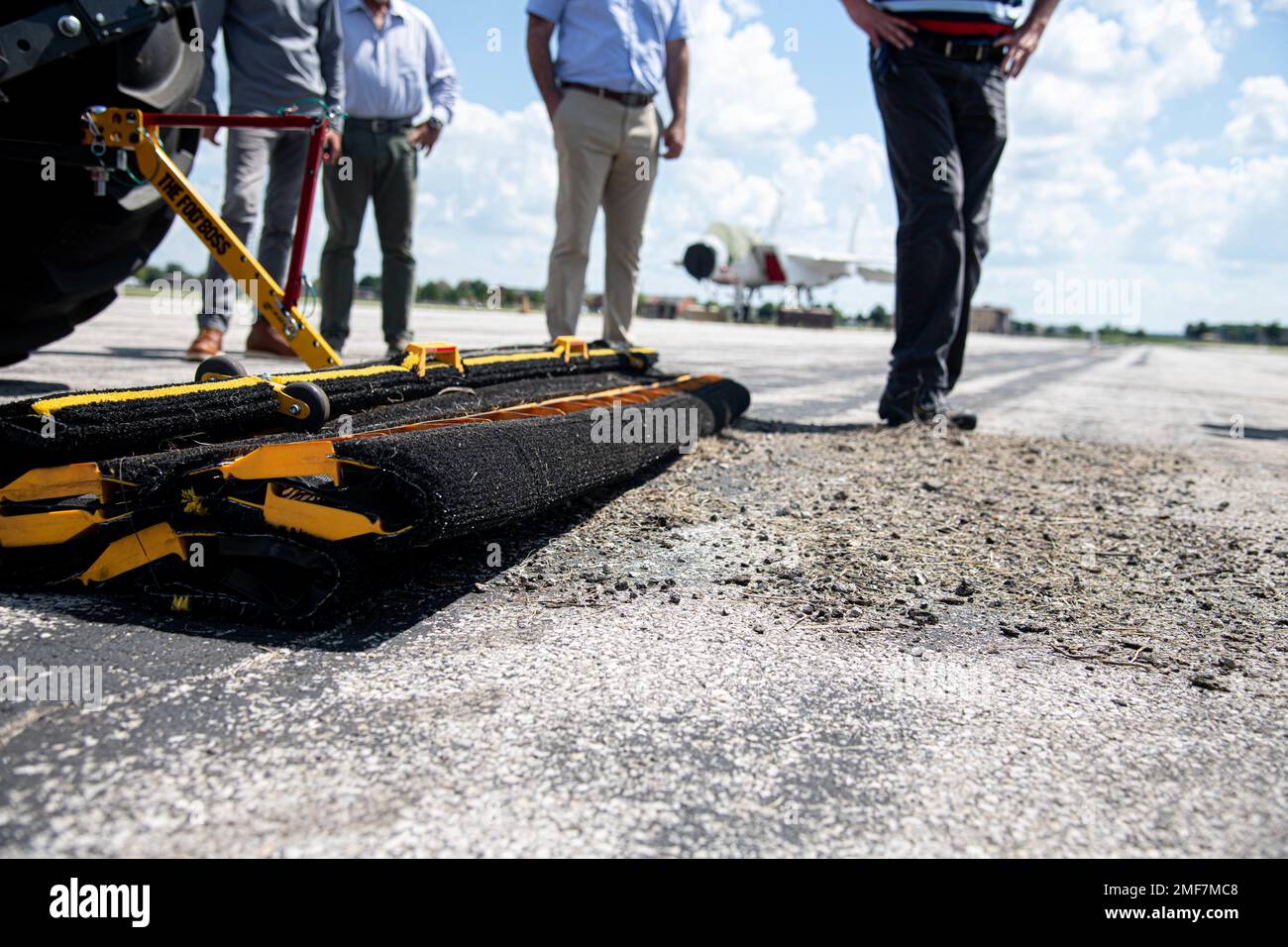 A mat designed to pick up foreign objects and debris sits affixed to an ...