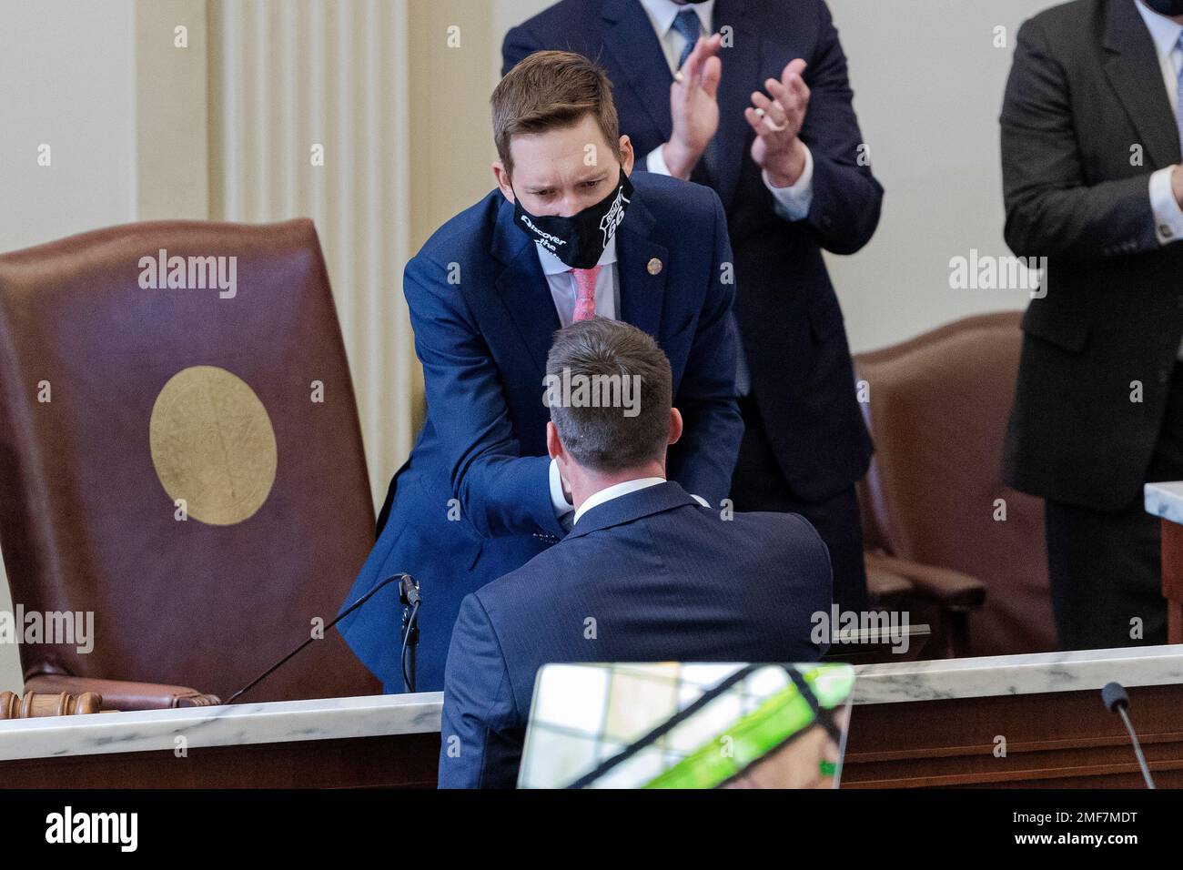 Oklahoma Lt. Gov. Matt Pinnell, back, fist bumps Kevin Stitt following ...