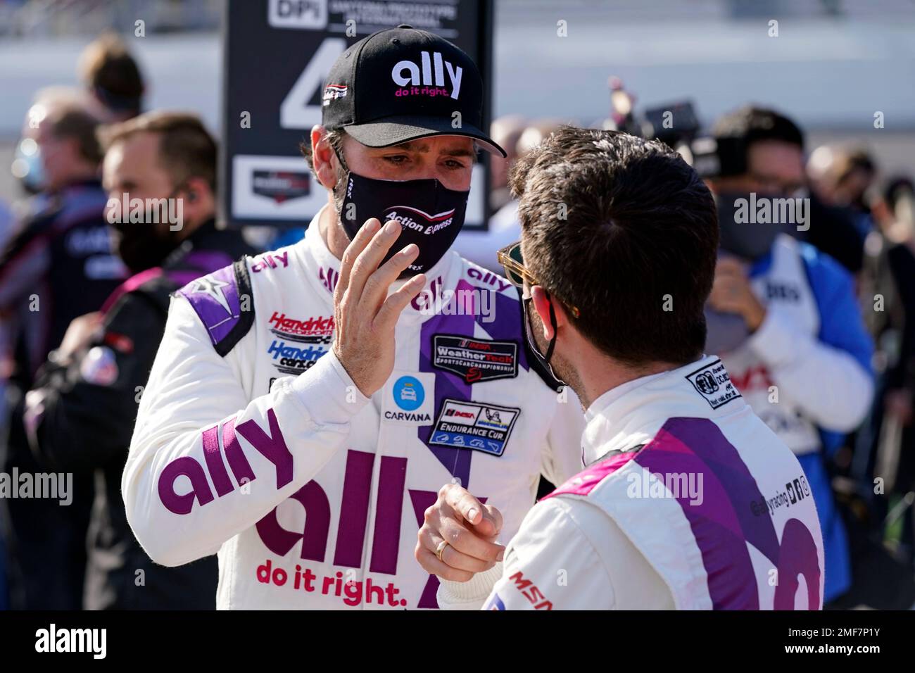 Jimmie Johnson, left, and Mike Rockenfeller talk on pit road before the ...