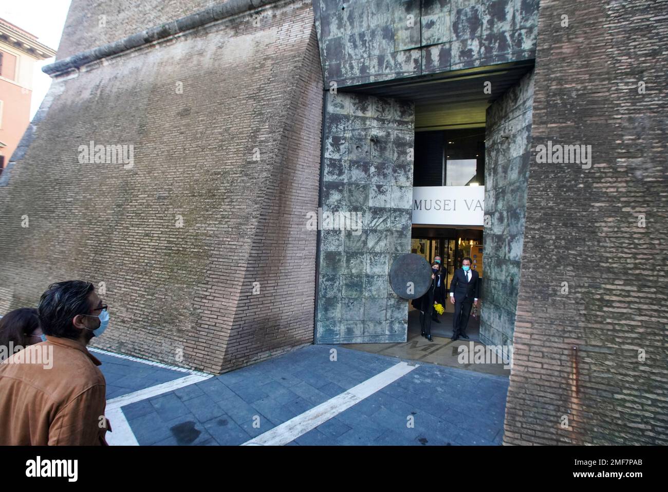 The first visitors of the day enter the Vatican Museums, at the Vatican ...