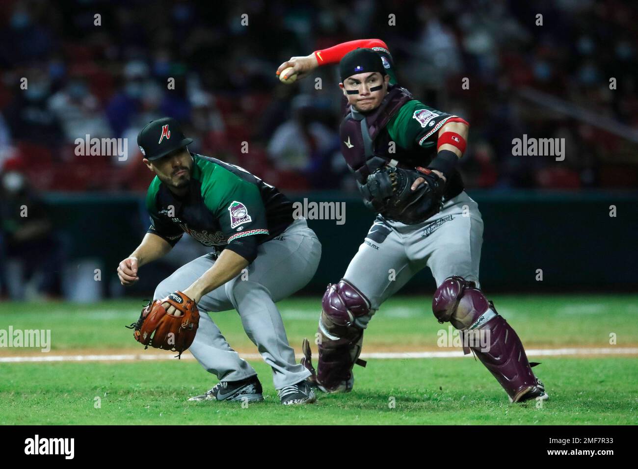 Mexico's Alexis Wilson prepares to throw to first base to put out ...