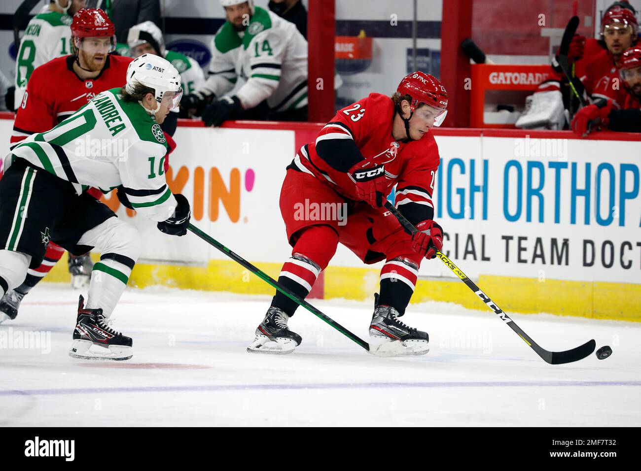 Carolina Hurricanes' Jake Bean (24) controls the puck in front of ...