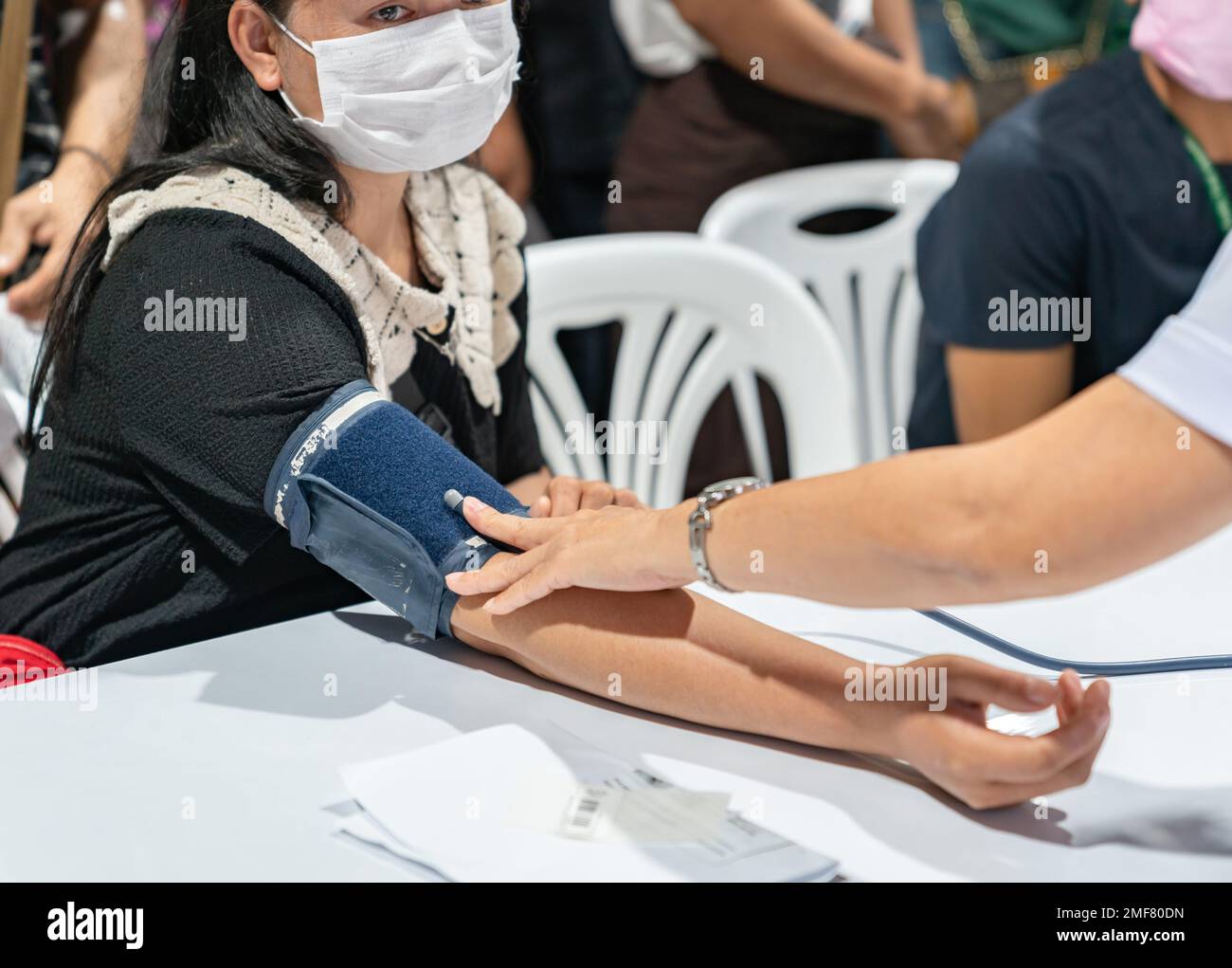 Nurse checking senior patient's blood pressure at annual helth check ...