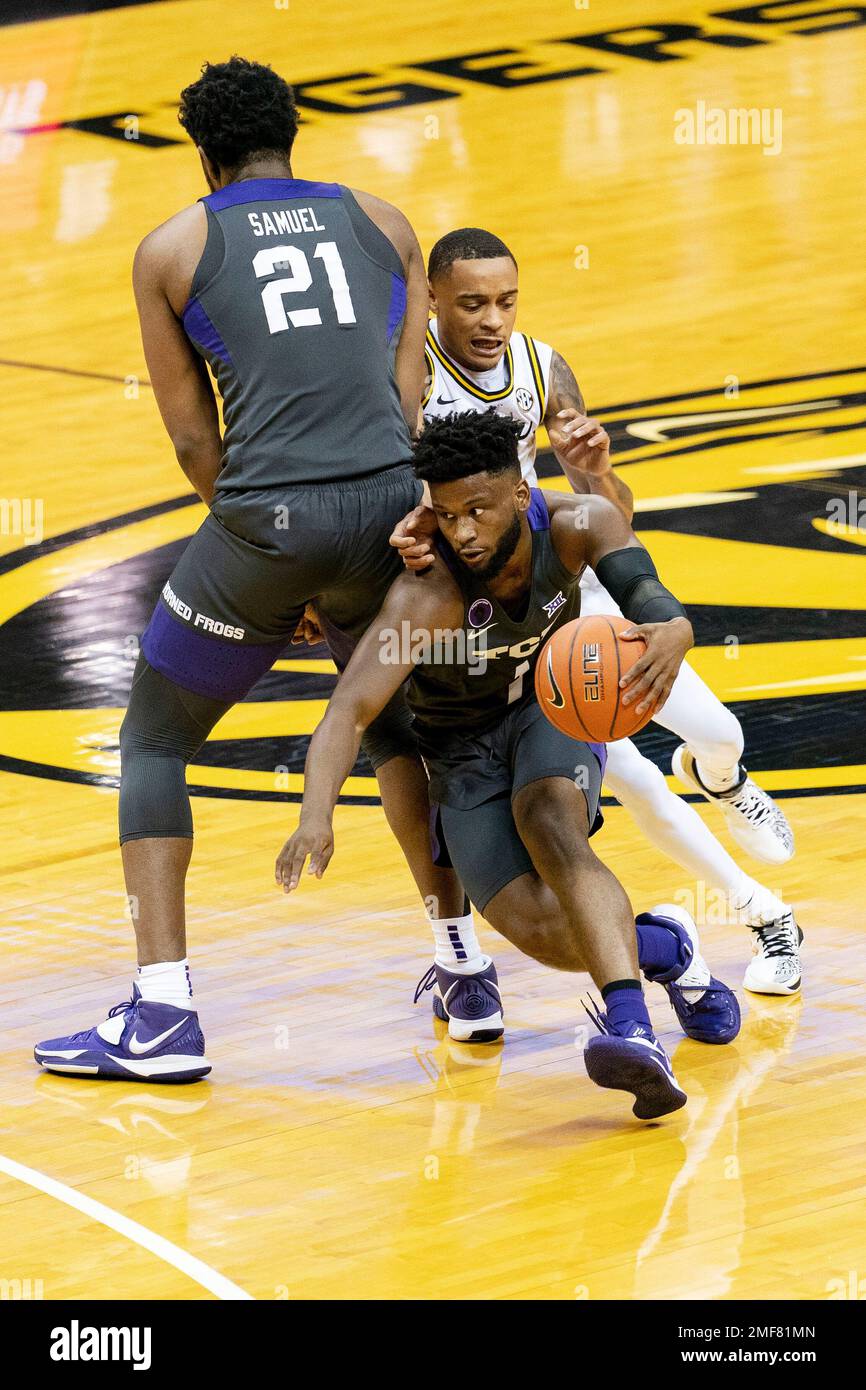 TCU's Mike Miles, center, dribbles around teammate Kevin Samuel, left ...