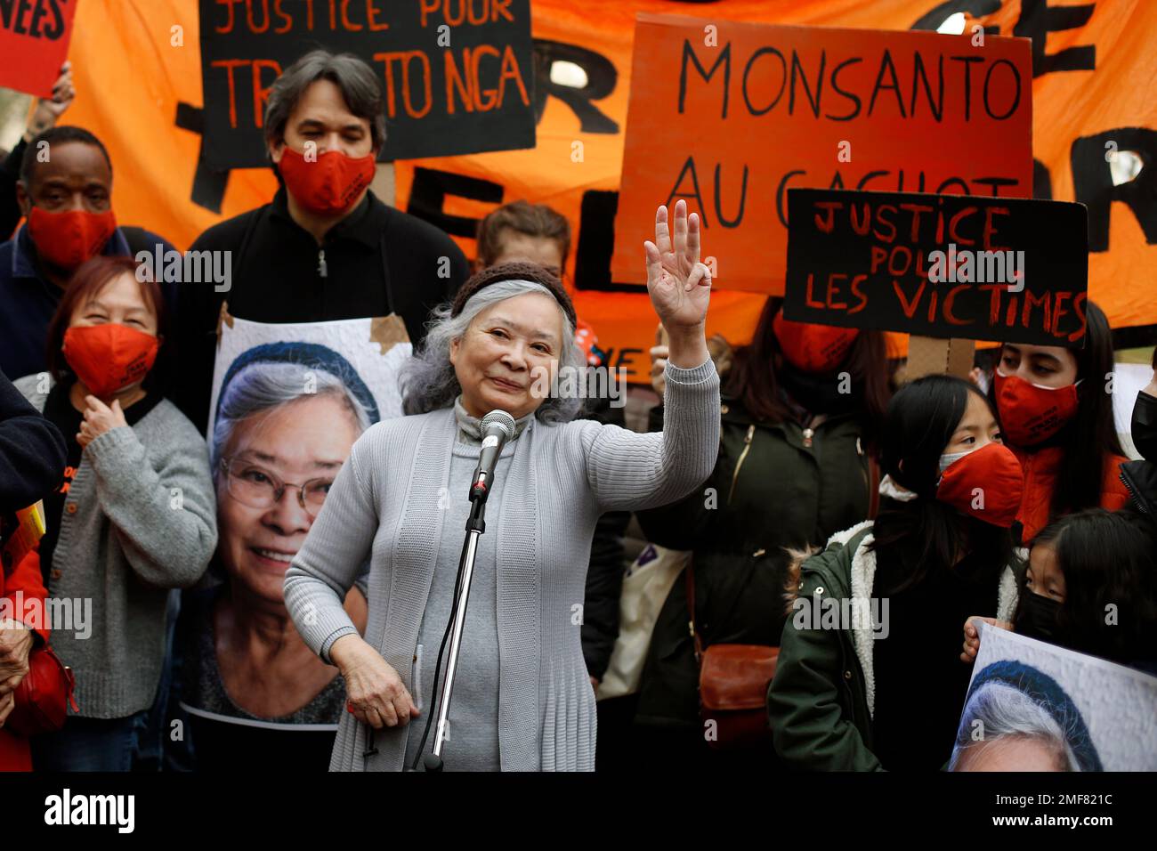 Tran To Nga, a 78-year-old former journalist, waves as she delivers a ...