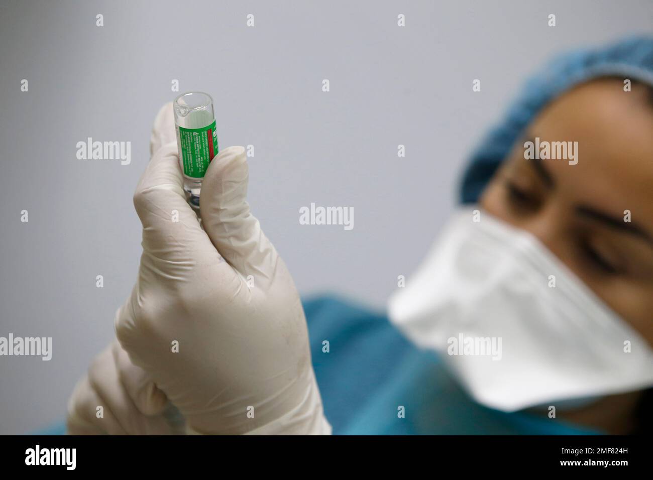 A Moroccan nurse prepares to administer a vial of the Oxford ...