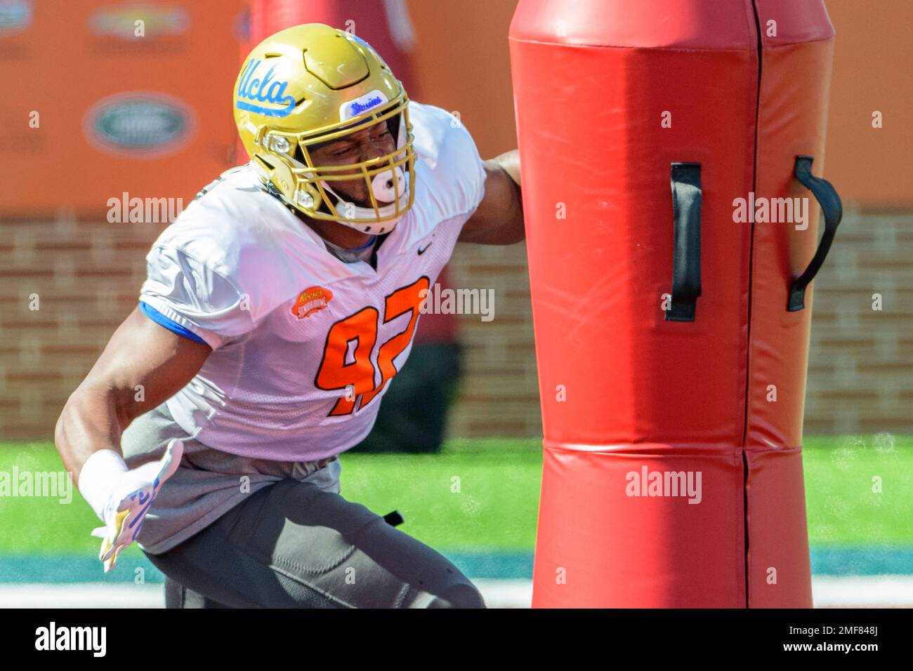 National Team offensive lineman Osa Odighizuwa of UCLA (92) runs a ...