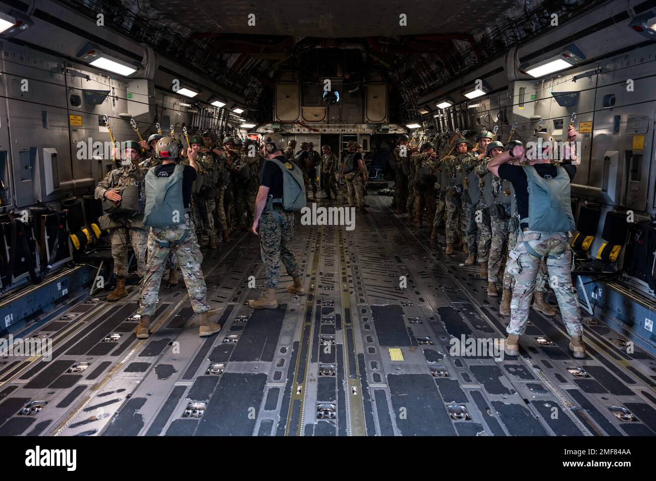Members of Jumpmaster School Class 007-22 prepare for a static line ...