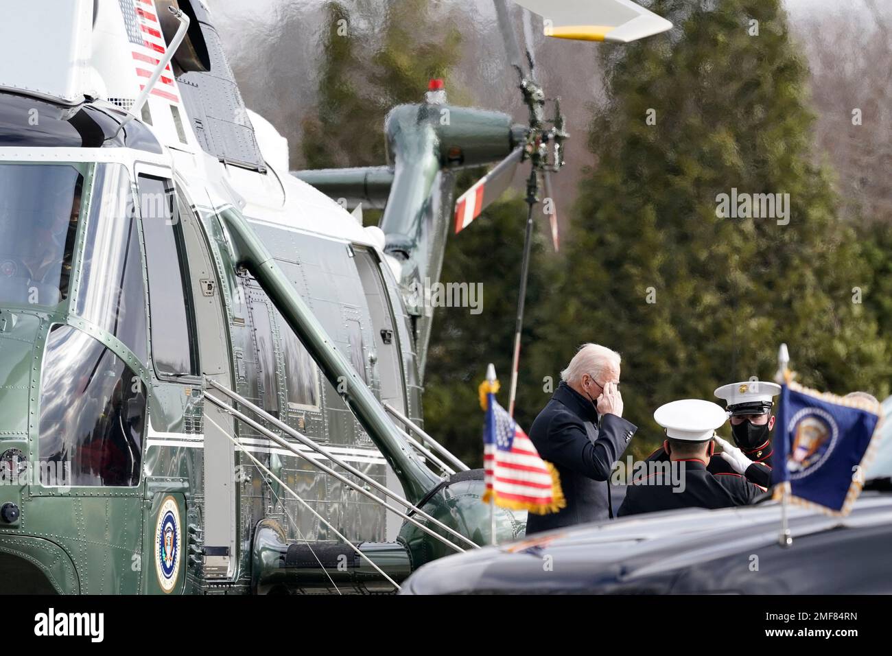 President Joe Biden salutes while exiting Marine One as he arrives at ...