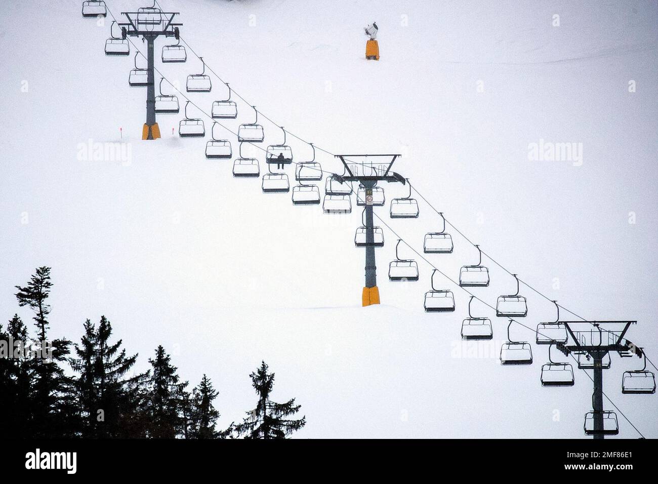 A man sits in a chairlift in the Austrian province of Tyrol, in Seefeld ...