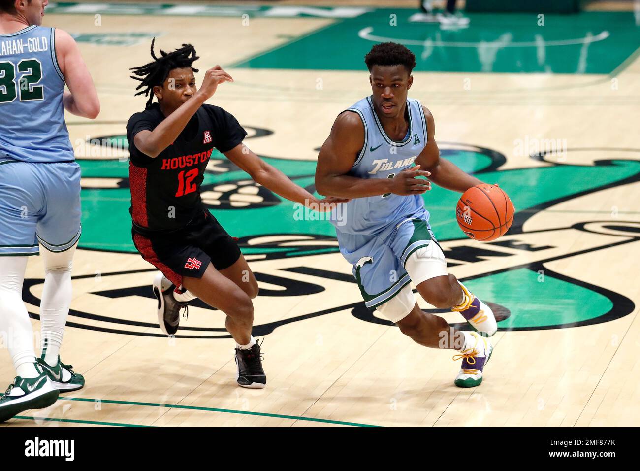Tulane guard Sion James (1) drives past Houston guard Tramon Mark (12 ...
