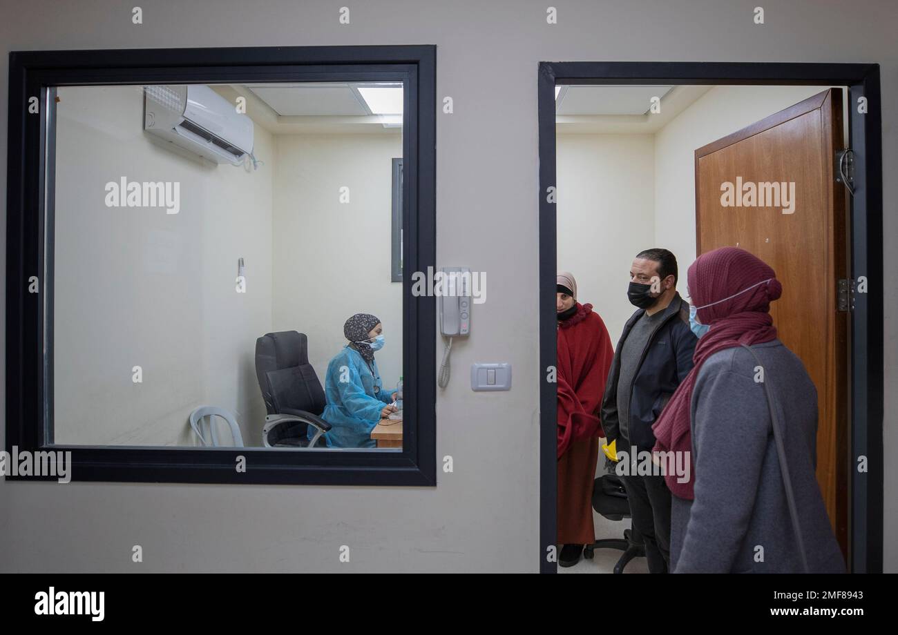 A medical staffer registers Palestinian patients infected with COVID-19 ...