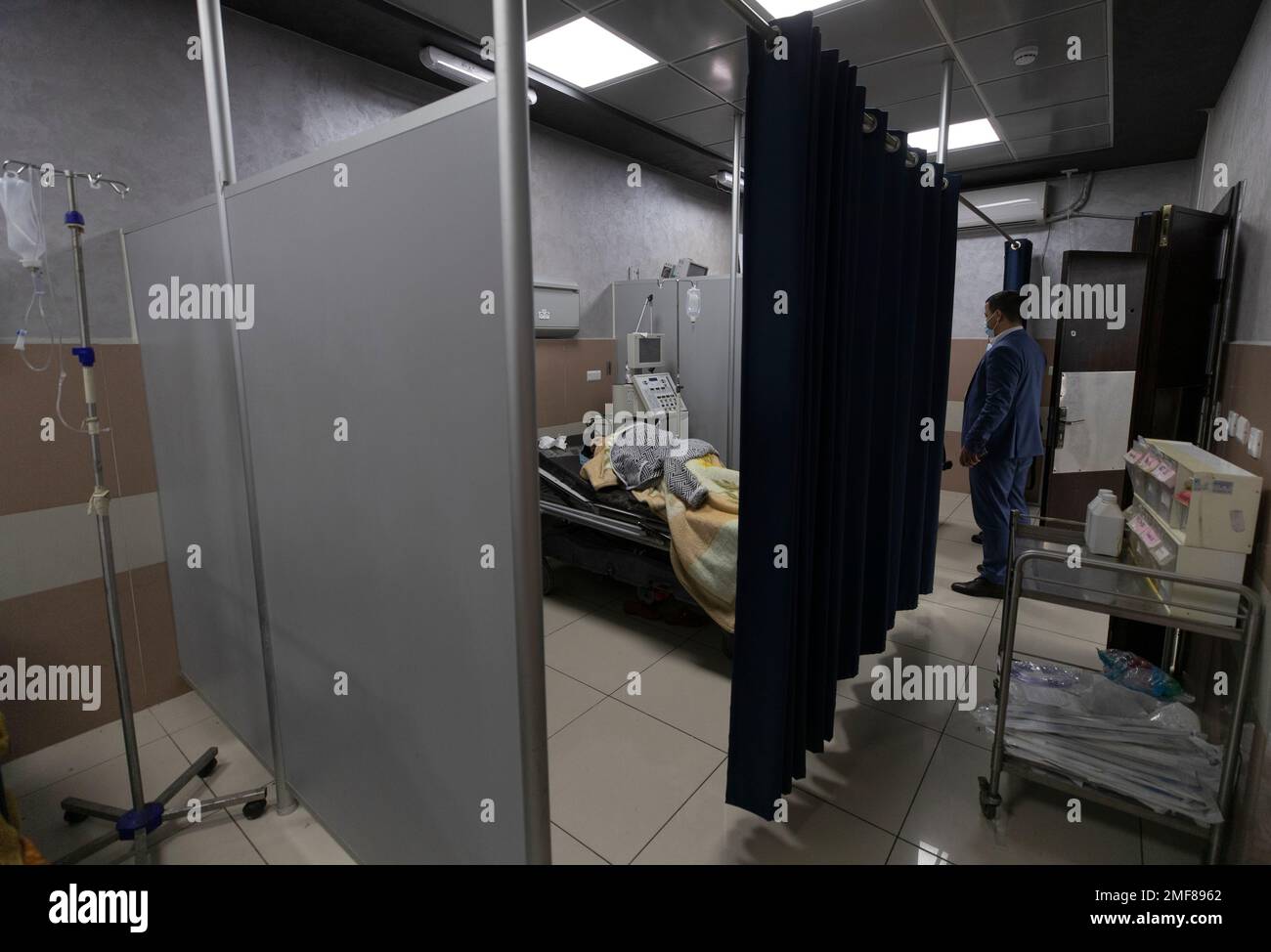 A female Palestinian patient infected with COVID-19 lies under medical ...