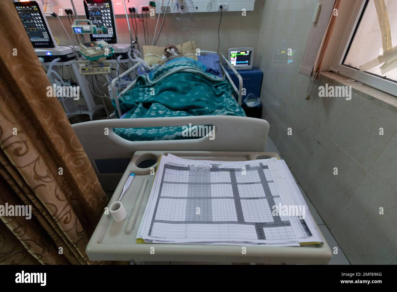 A Palestinian COVID-19 patient lies on a medical bed of the intensive ...