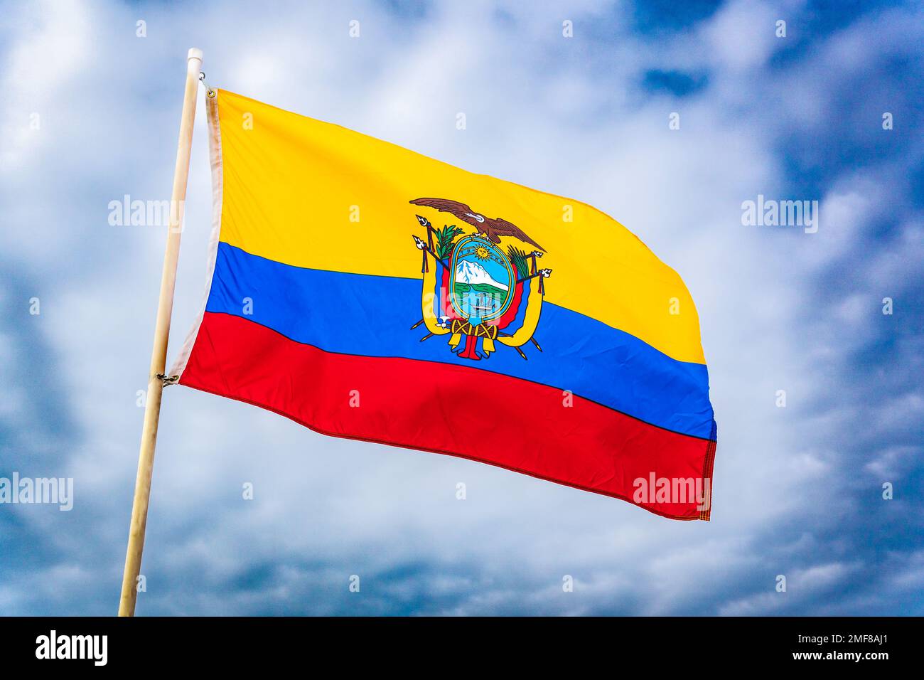 National flag of the Republic of Ecuador flowing in wind with blue sky ...