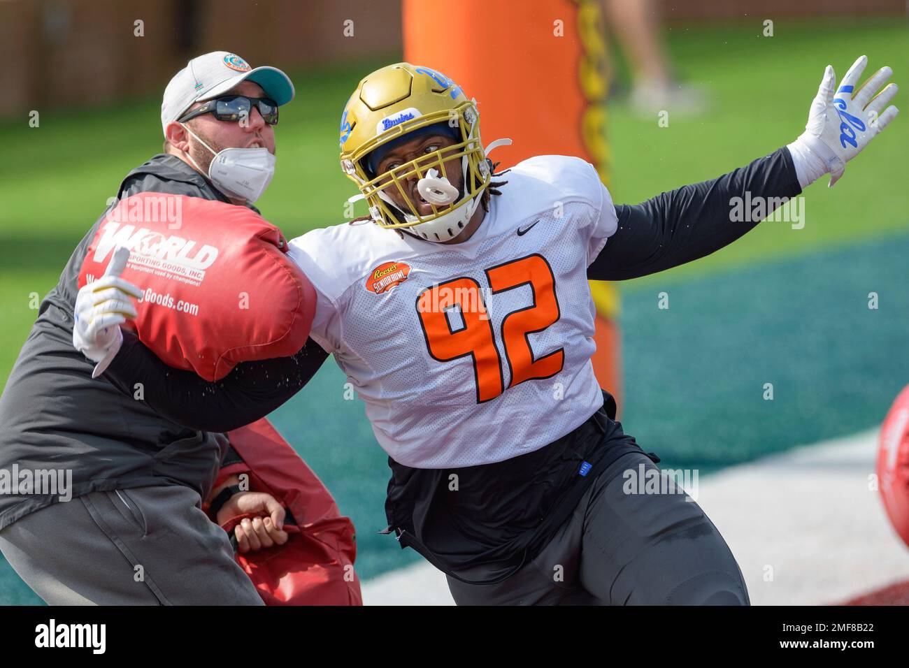 National Team offensive lineman Osa Odighizuwa of UCLA (92) runs a ...