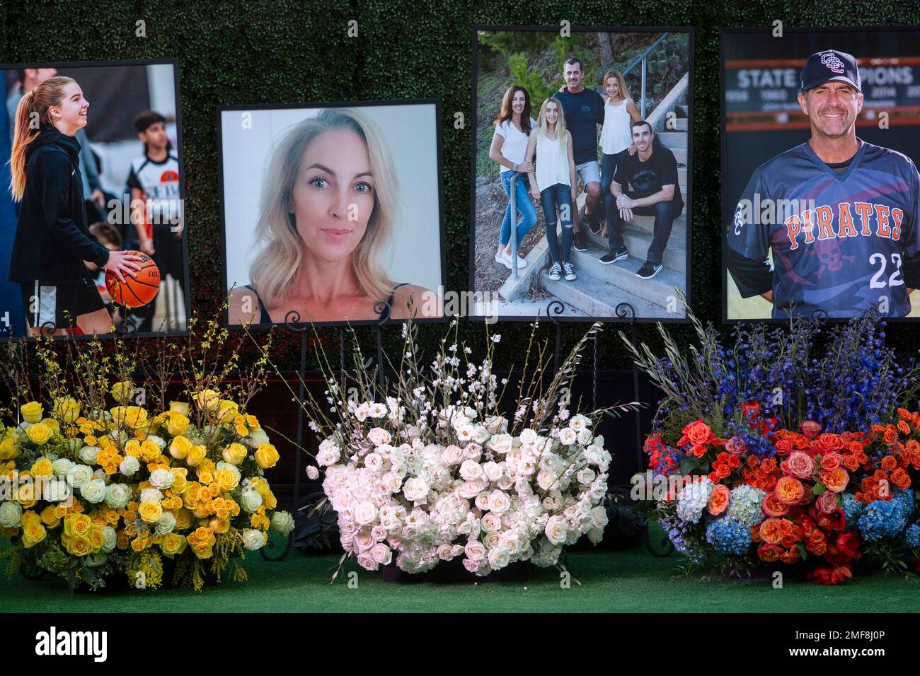 FILE - In this Feb. 10, 2020, file photo, flowers and photos honor ...