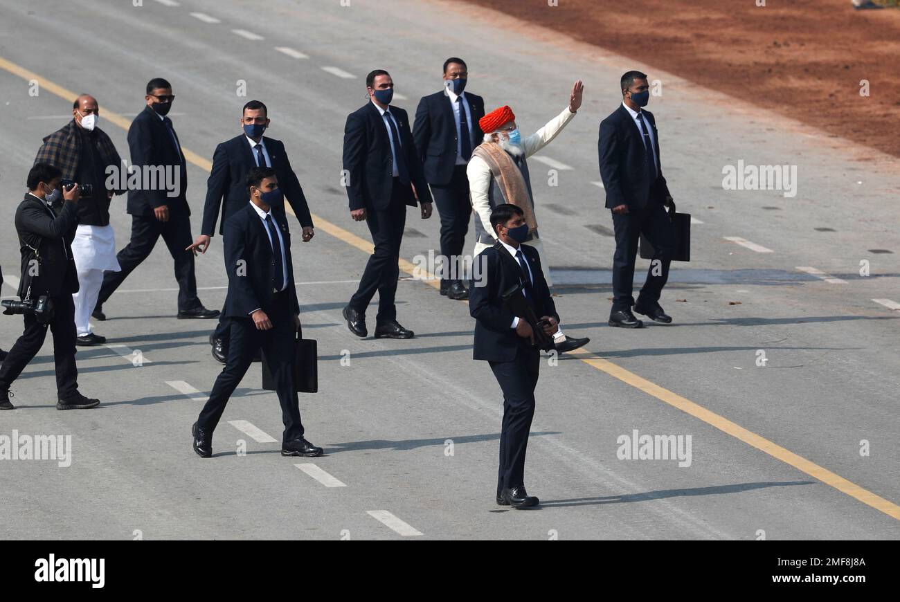 Indian Prime Minister Narendra Modi, red cap, waves as he returns after ...