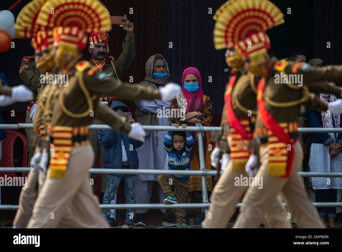People watchIndian paramilitary Sasastra Seema Bal personnel march ...