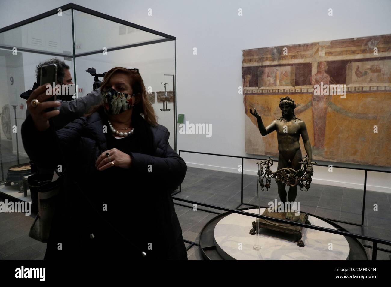 Journalists film a statue of Ephebos at the museum Antiquarium, in ...