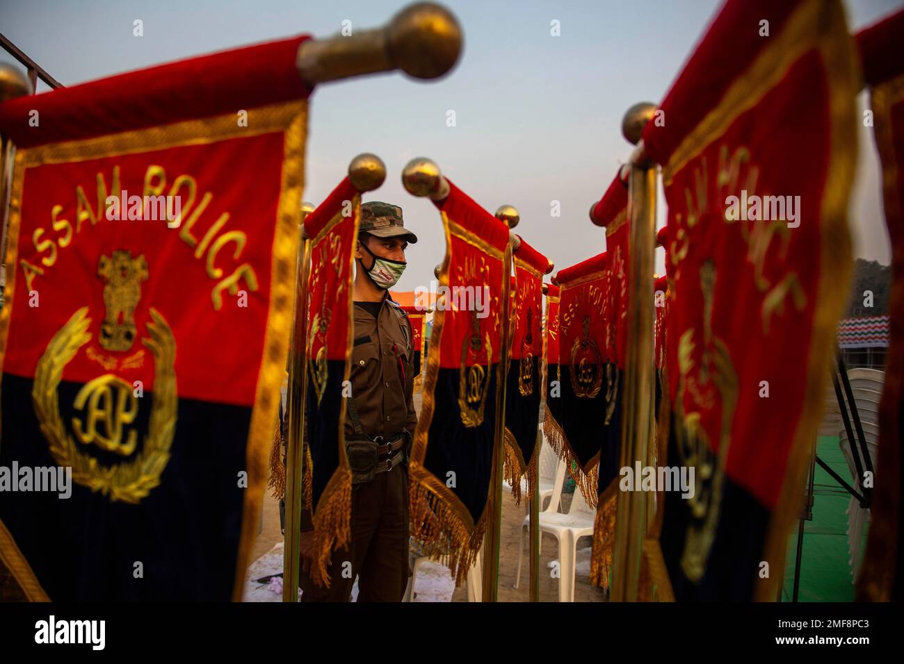 An Assam police person looks on as a worker, unseen, prepares the ...