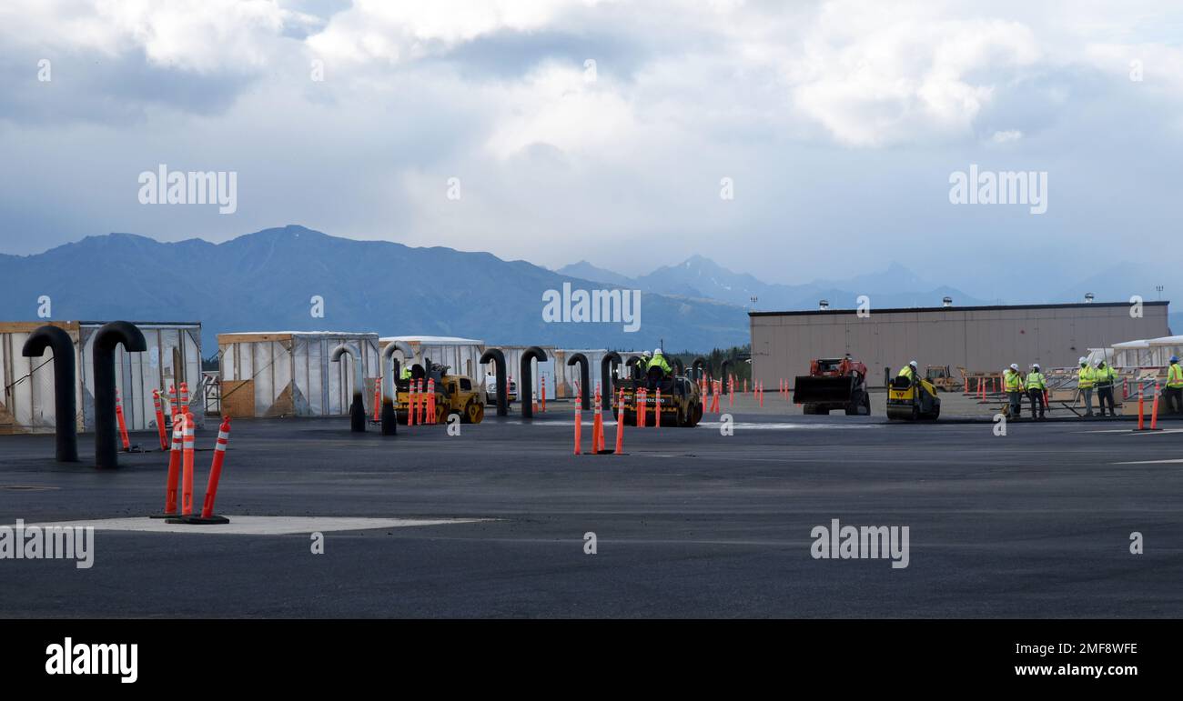 Construction crews smooth newly poured pavement at missile field 4 at ...