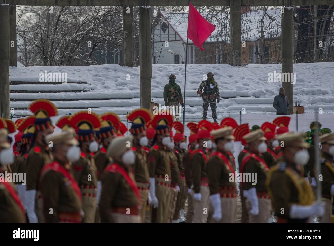 Indian paramilitary soldier stands guard as their colleagues take part ...