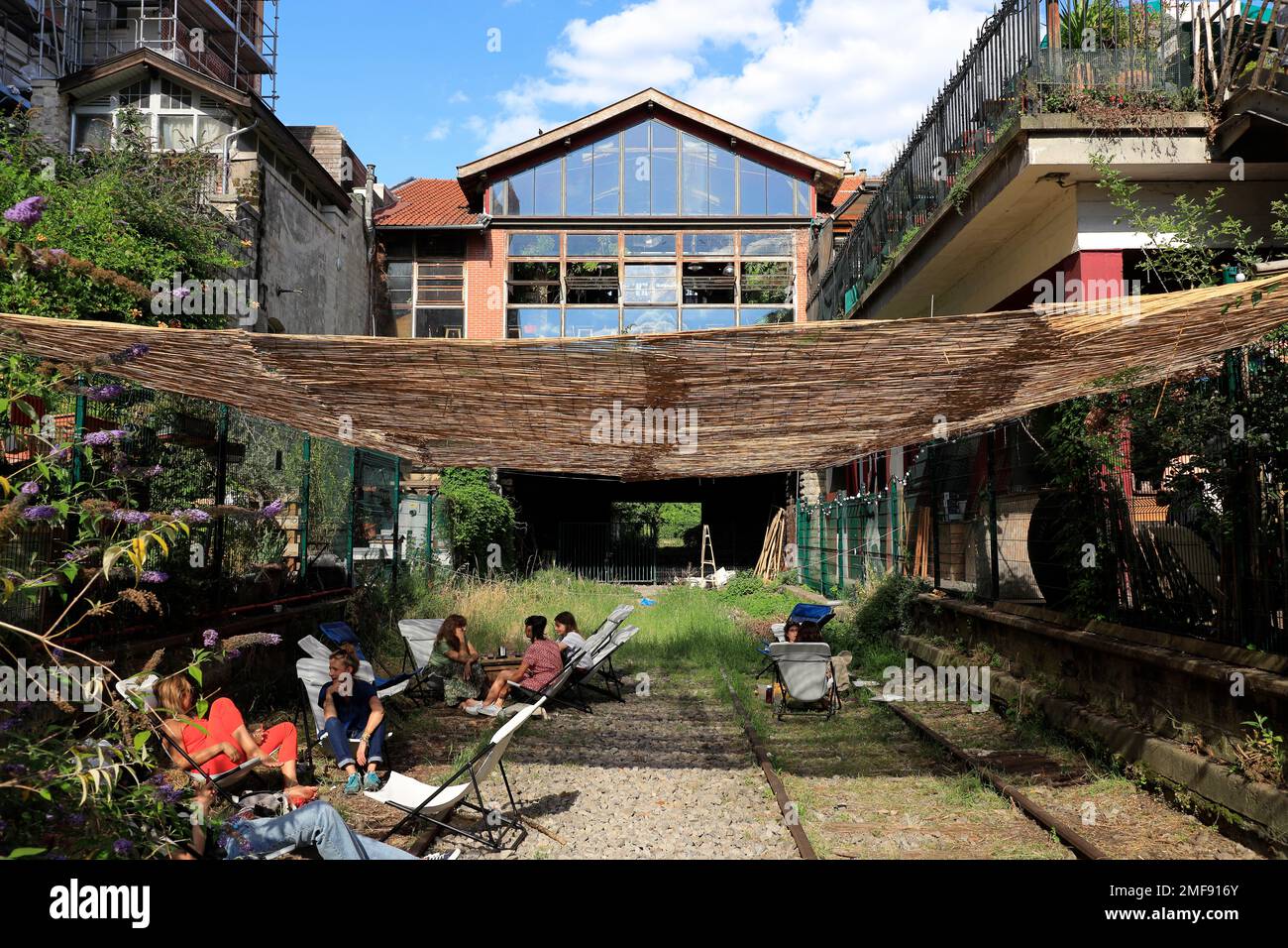 Visitors in outdoor cafe and farm of La REcyclerie, an urban farm and ...