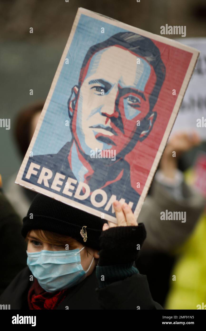 A woman shows poster with a drawing of Russian opposition leader Alexei ...