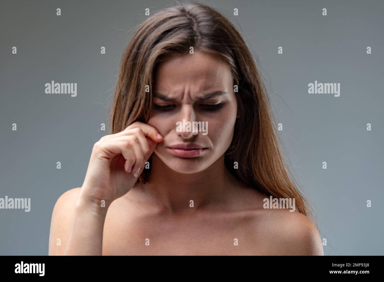 Portrait of young woman expressing sadness but in a nice and funny way ...