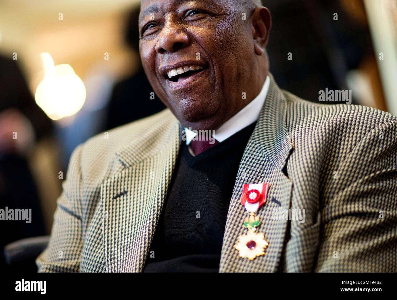 Hank Aaron smiles after being presented with the Order of the Rising ...