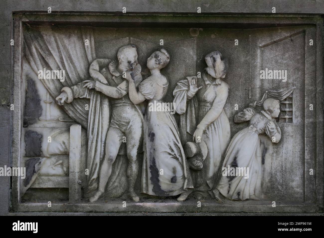 A closed up view of stone carved relief decorating a tomb stone inside ...
