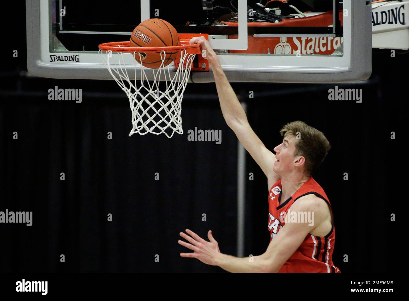 Utah center Branden Carlson dunks during the first half of the team's ...