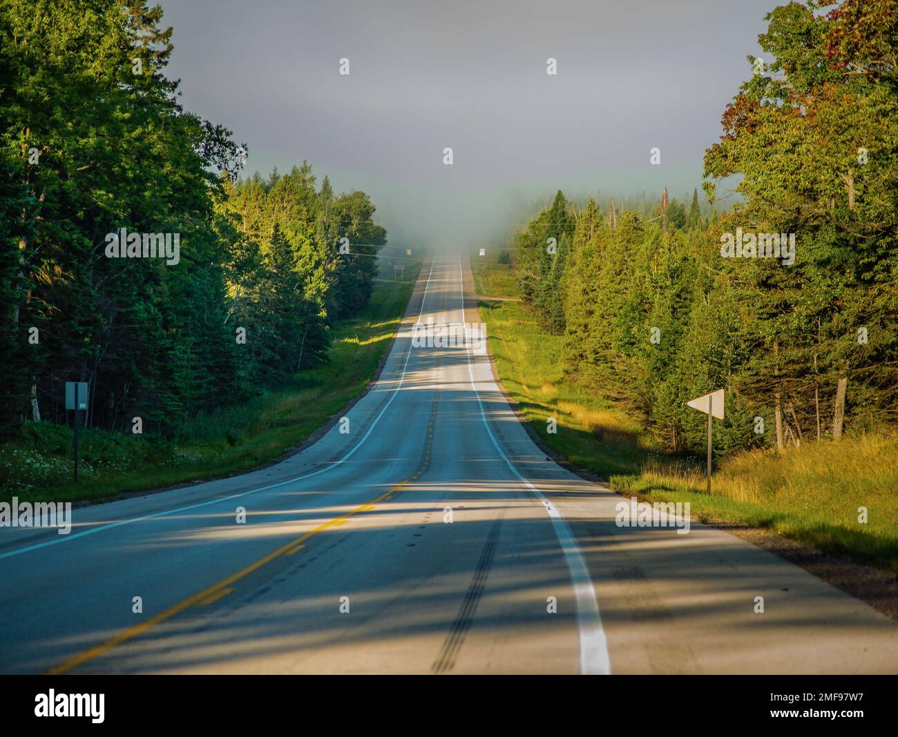 Fog drifting over roadway in Michigan Upper Peninsula Stock Photo - Alamy
