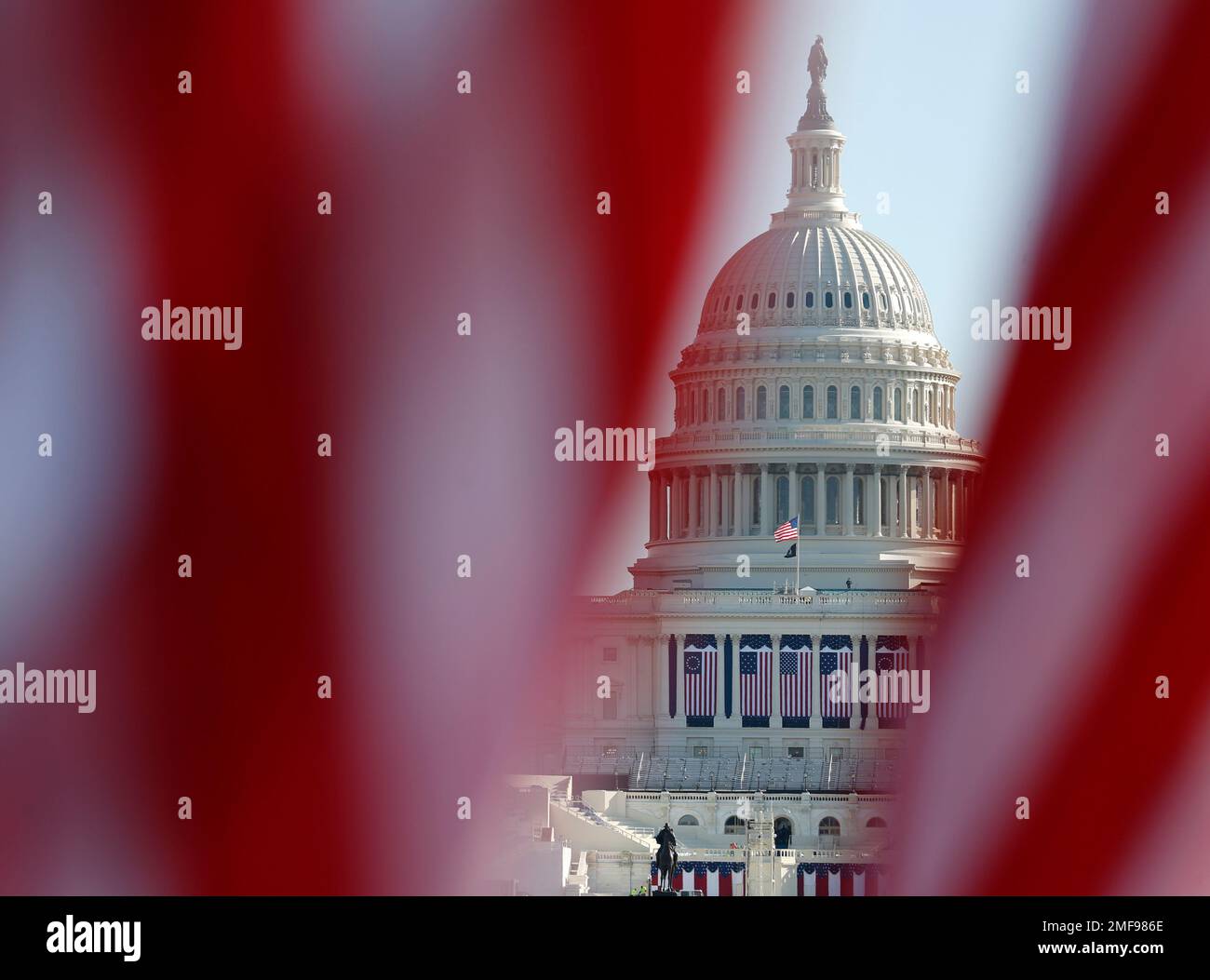 The U.S. Capitol is seen through a display of flags on the National ...