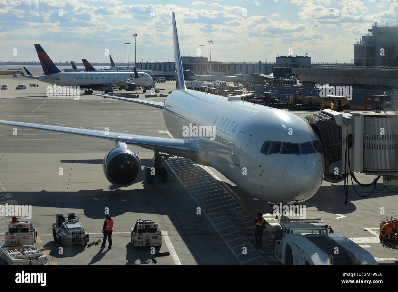 A Delta Air Lines passenger airplane connected with a jet bridge in ...