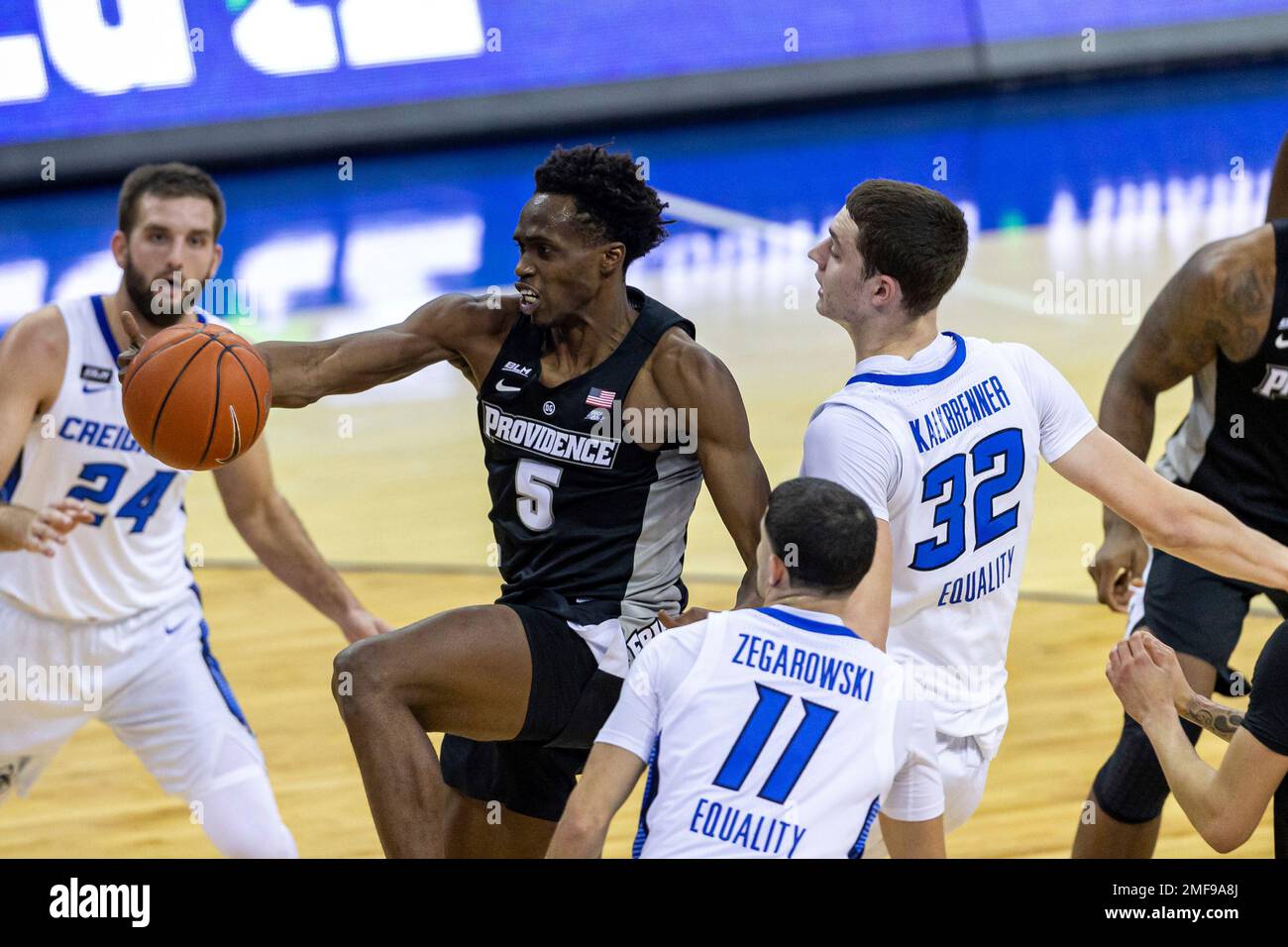 Creighton center Ryan Kalkbrenner (32) fouls Providence forward Jimmy ...