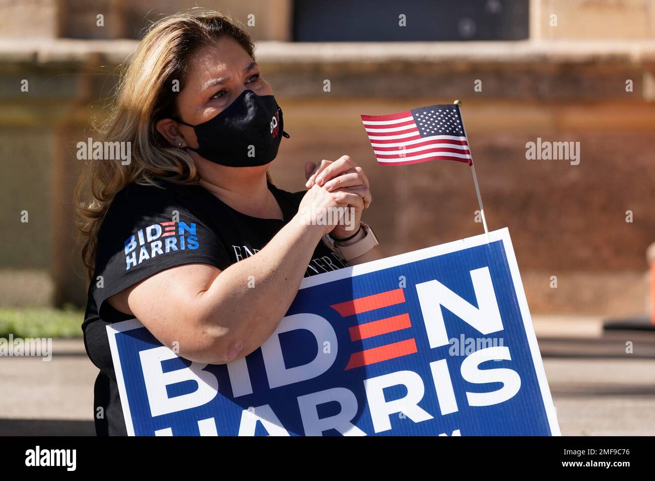 Jonelle, of Miami, who declined to give her last name, watchs the ...