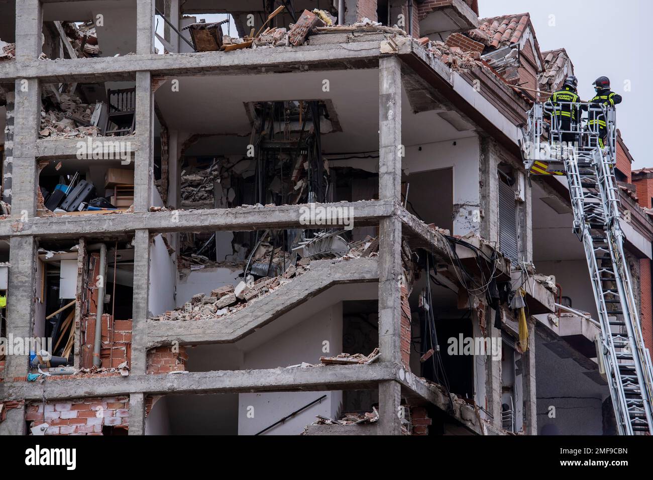 Firefighters inspect the debris caused by an explosion in downtown ...