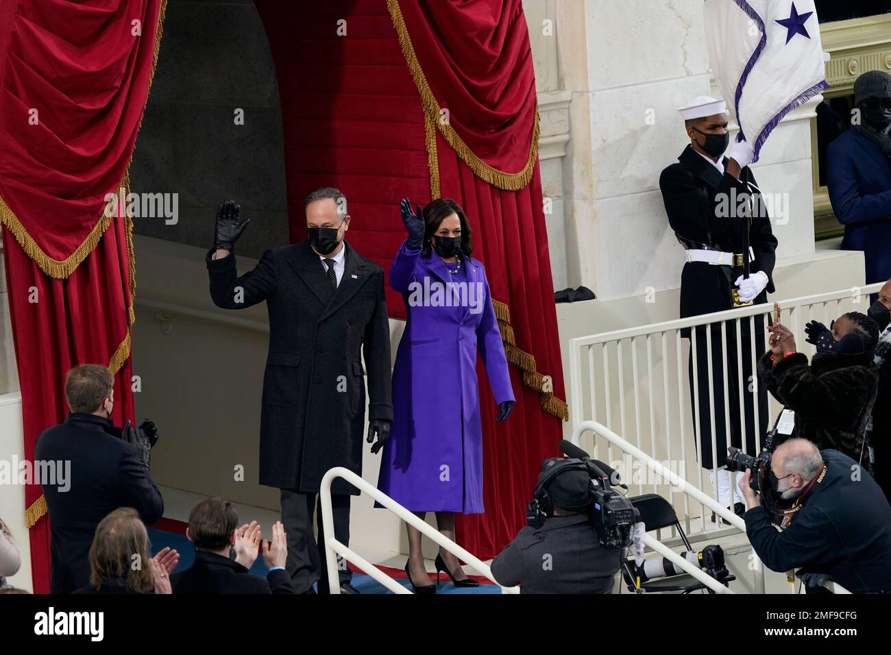 Vice President-elect Kamala Harris and her husband Doug Emhoff, wave as ...