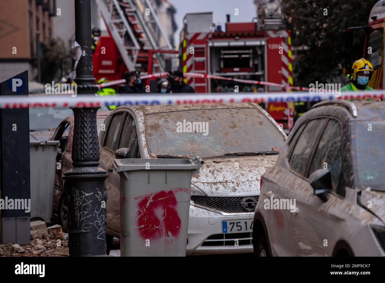 A car is covered by debris following an explosion in downtown Madrid ...