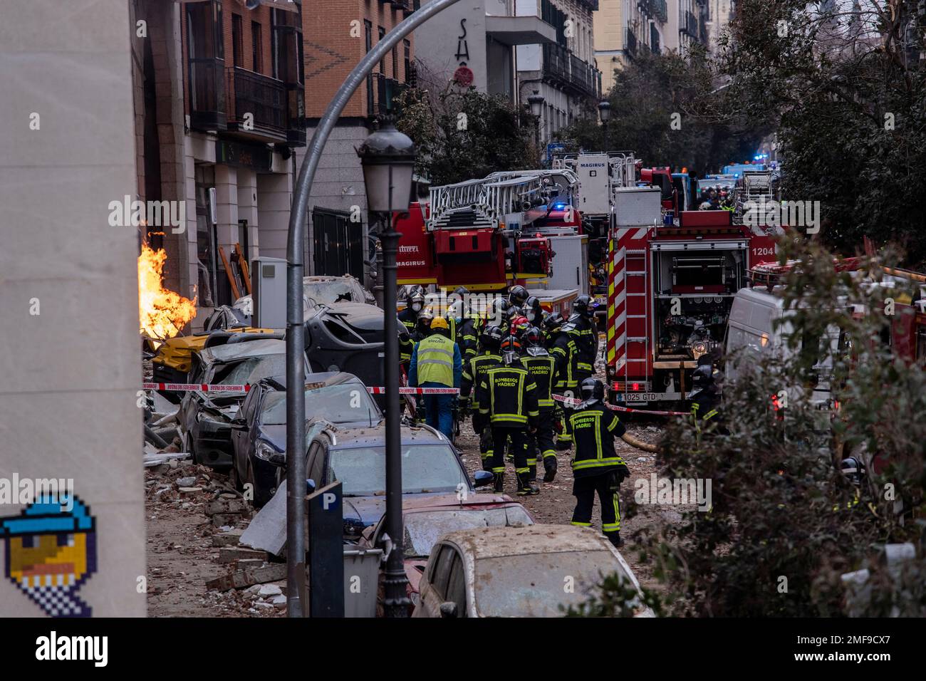 Firefighters work at the scene of an explosion in downtown Madrid ...